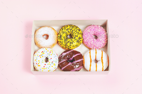 Donut box. A set of glazed colored donuts with sprinkles and toppings ...