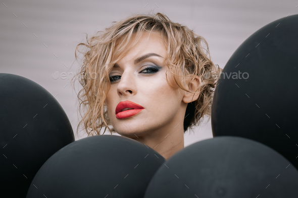 Portrait beautiful woman of model appearance with dark balloons. Art ...