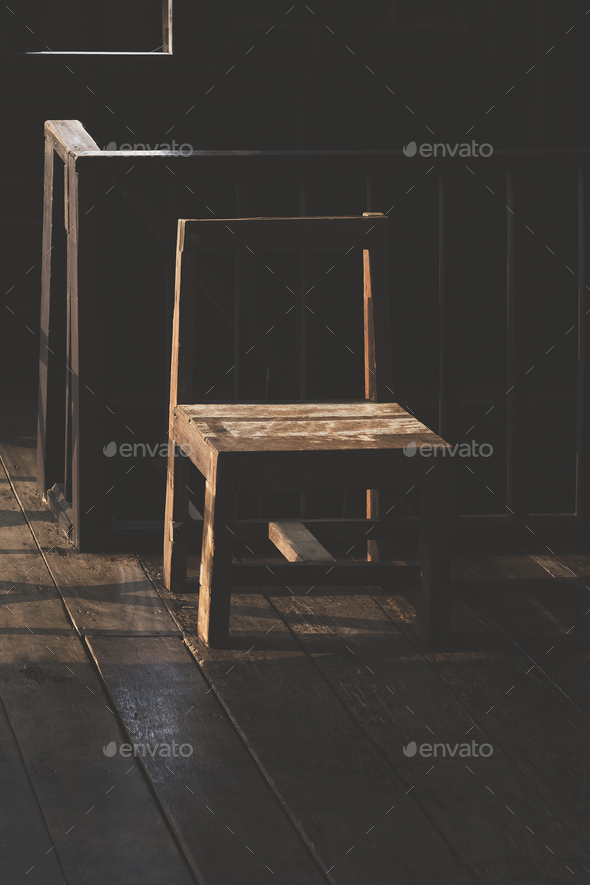 Light and shadow on surface of the old empty wooden chair near the ...