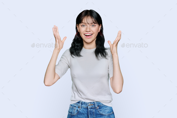 Young happy woman holding hands up, on white background Stock Photo by ...