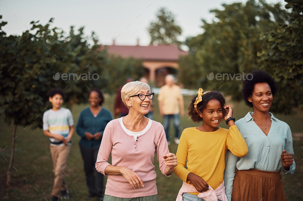Happy multiracial extended family enjoying in the backyard. Stock Photo ...