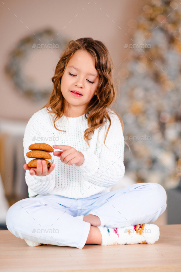 Smiling kid girl eating Christmas cake Stock Photo by morrowlight ...