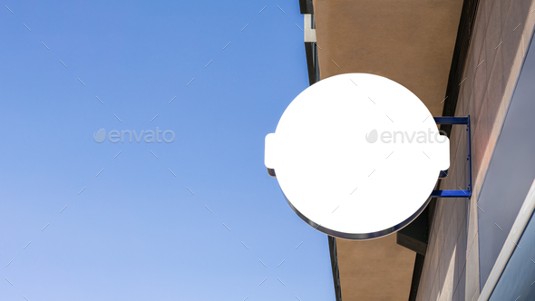 Blank circle sign mockup in the urban environment, on the facade empty ...