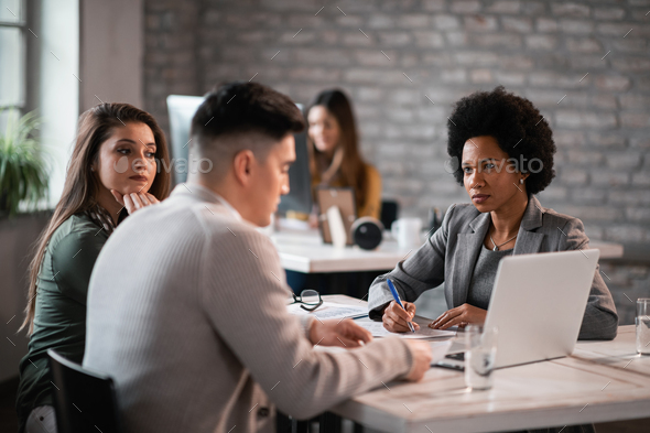 Black female bank manager on a meeting with young couple. Stock Photo ...