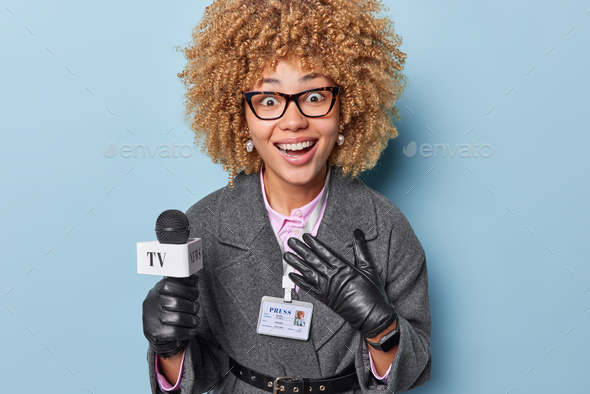 Happy surprised female TV reporter laughs gladfully wears transparent ...