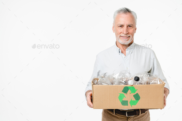 Mature middle-aged eco-activist volunteer holding carton box full of ...