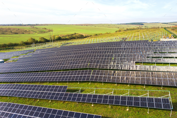 Aerial view of solar power plant under construction on green field ...