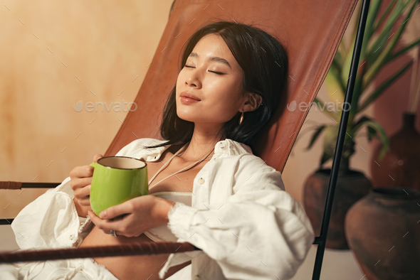 Close-up of korean woman having rest after work enjoying relaxing ...