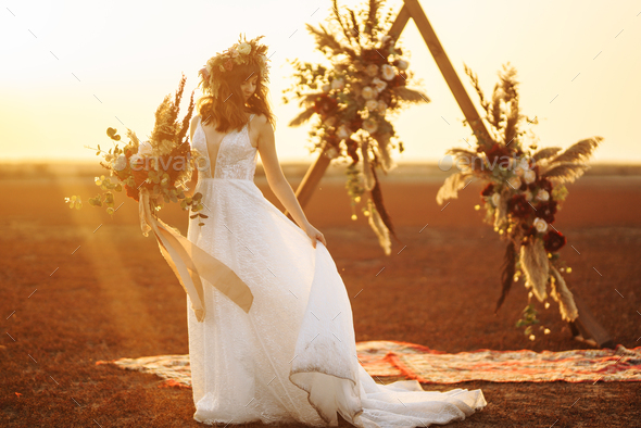 Bride in sunset light. Pretty bride. Boho style. Bride wearing fashion ...