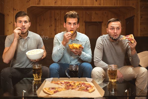 The three friends sit and eat food Stock Photo by artemp3 | PhotoDune