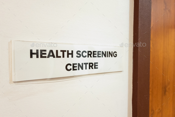 Concept of the word Health Screening Centre at the door entrance of ...