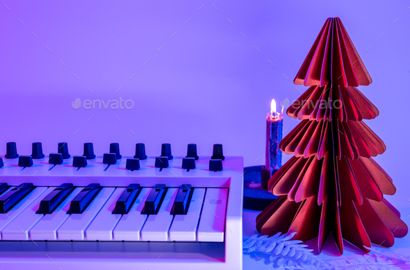Christmas background with midi keyboard and holiday decor with neon ...