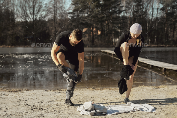 Caucasian man and woman taking off clothes before winter swimming Stock ...