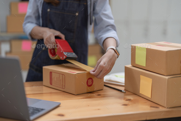 Startup small business, Young woman working freelance and packing box delivery products to Stock ...