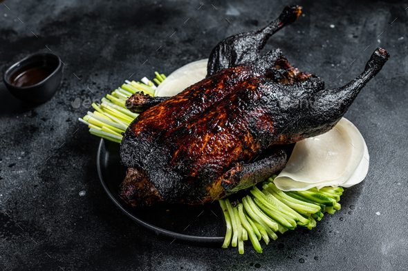 Traditional whole roasted Christmas Peking duck with herbs and sauce ...