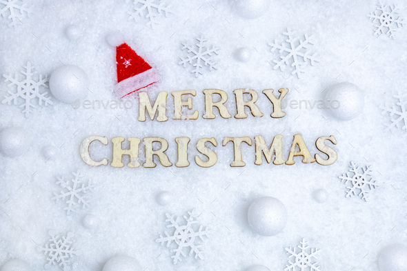 Merry christmas card, n wooden letters on white snow, snowflakes ...