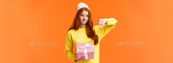 Skeptical and awkward cute redhead picky girl dont like christmas gift ...