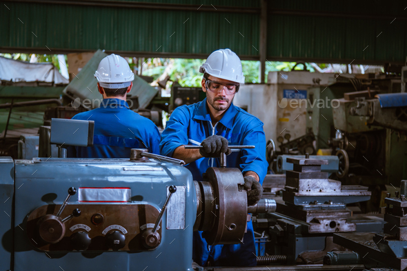 The Industry worker wearing safety uniform, glass and ear phone control ...