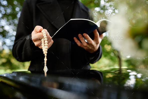 Close up of priest holding bible and rosary Stock Photo by ...