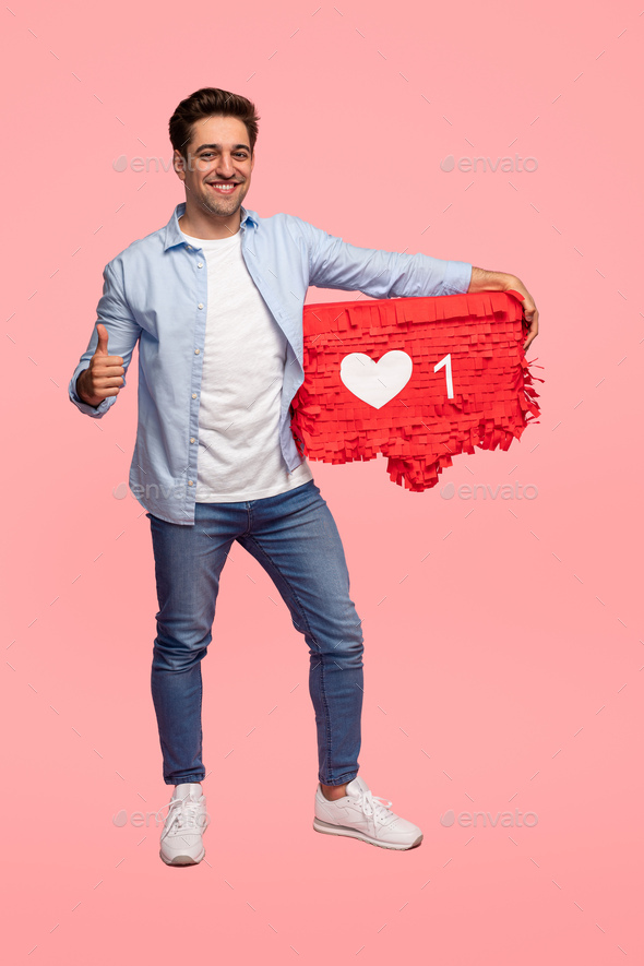 Cheerful young man with like sign Stock Photo by kegfire | PhotoDune