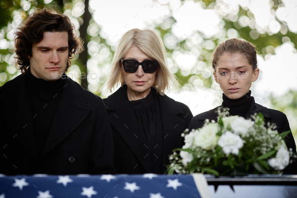 Family wearing black at outdoor funeral ceremony Stock Photo by ...