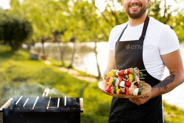 Crop cheerful chef with skewers Stock Photo by kegfire | PhotoDune