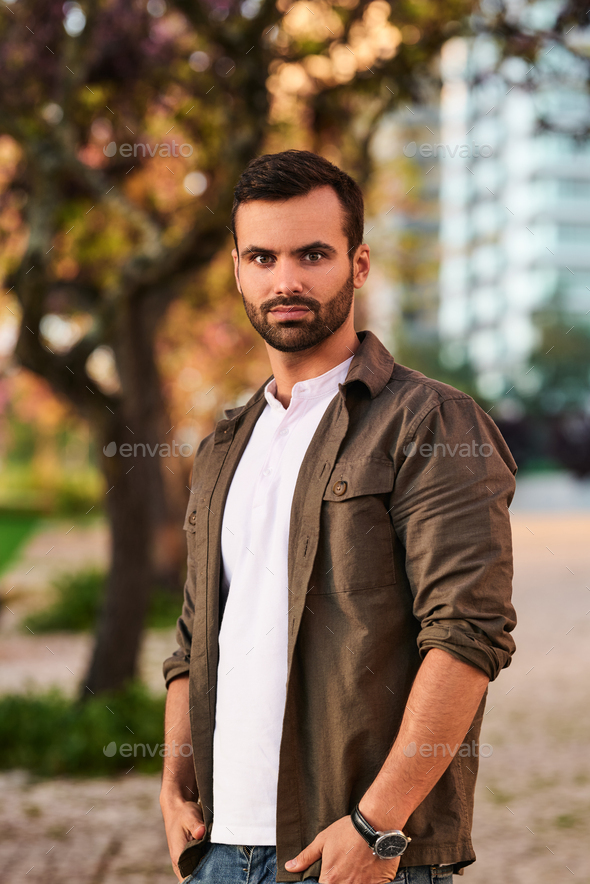 Cool young Middle Eastern guy looking at camera in urban park Stock ...