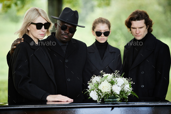 People standing by coffin at funeral ceremony Stock Photo by ...