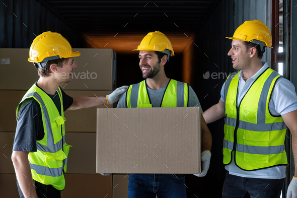 3 Workers carry carton box take from 40 feet steel container on the ...