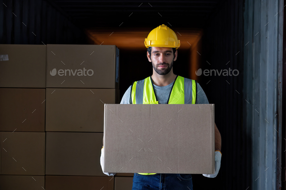 Worker carry carton box taken from 40 feet steel container on the ...