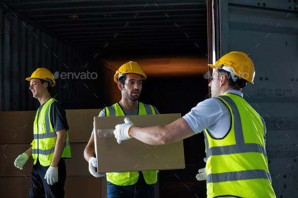 3 Workers hand carry carton box take from 40 feet steel container one ...