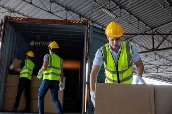 3 Workers hand carry carton box take from 40 feet steel container one ...