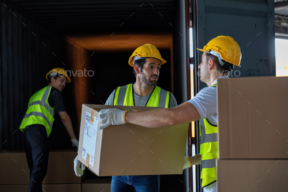 3 Workers hand carry carton box take from 40 feet steel container one ...