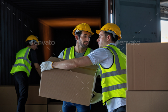 3 Workers hand carry carton box take from 40 feet steel container one ...
