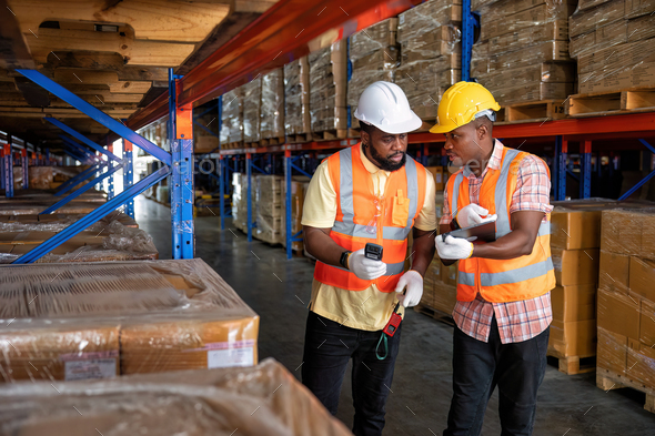 Foreman and worker in warehouse checking carton box barcode store at ...