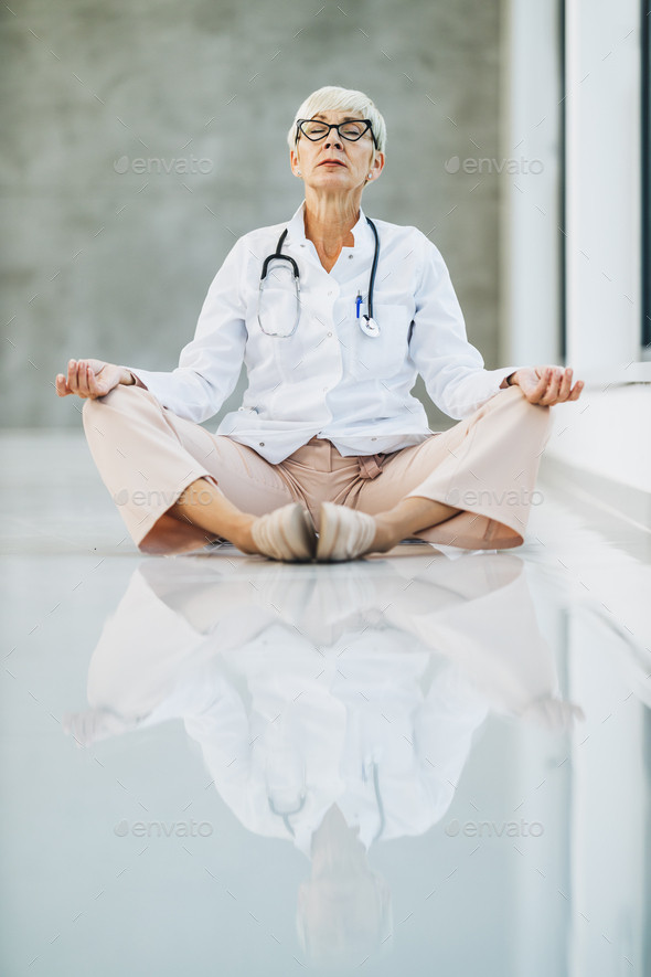 A Doctor Meditating In The Lotus Posie At The Empty Hospital Hallway ...