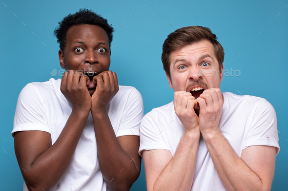 Frightened two men have scared expressions, look nervously Stock Photo ...