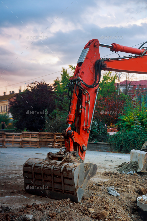 Excavator bucket digging ground for installing pipes the street Stock ...
