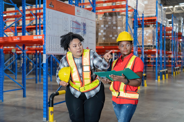 Diverse worker in warehouse hold check sheet looking storage scan ...