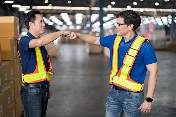 Manager and staff working in warehouse hand punch and check hand after ...