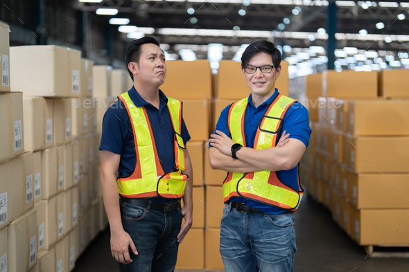 Manager and staff working in large storage warehouse one standing smart ...