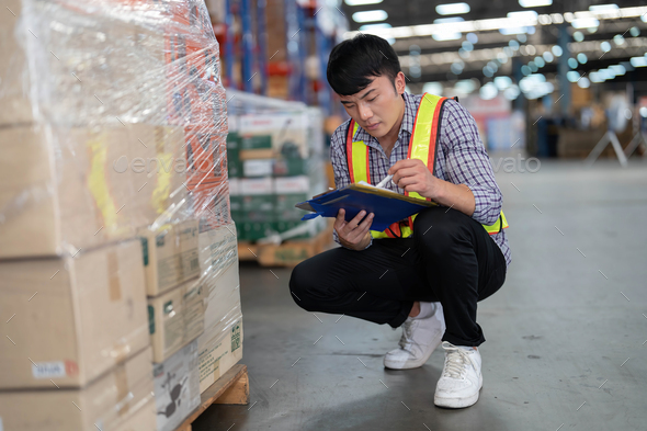 Worker in warehouse hold paper check list checking boxes wrapped with ...