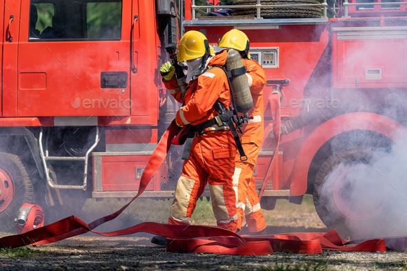 Firefighter wearing fire protection suite and oxygen tank exercise roll ...