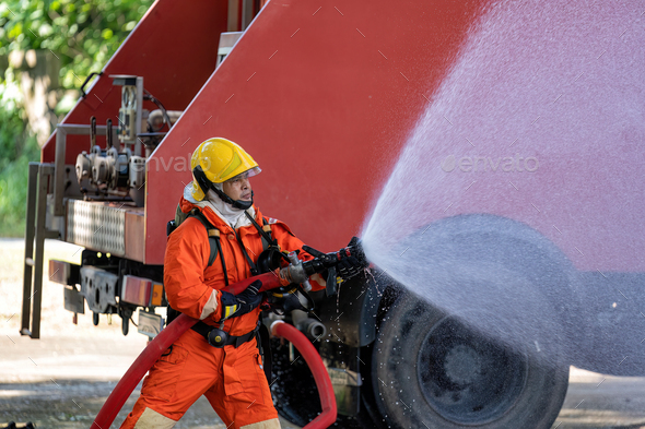 Fireman wearing fire protection suite and oxygen tank exercise hold ...