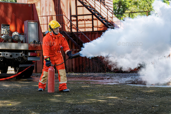 Fireman wearing fire protection suite and oxygen tank exercise hold ...