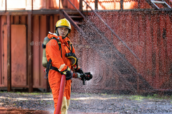 Fireman wearing fire protection suite and oxygen tank exercise hold ...