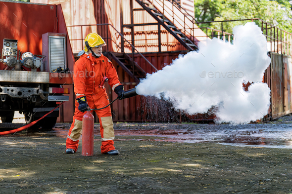 Fireman wearing fire protection suite and oxygen tank exercise hold ...
