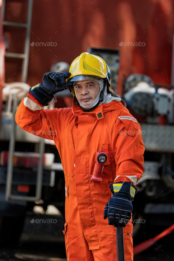 Fireman wearing fire protection suite and oxygen tank exercise hold axe ...