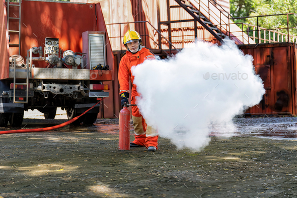 Fireman wearing fire protection suite and oxygen tank exercise hold ...