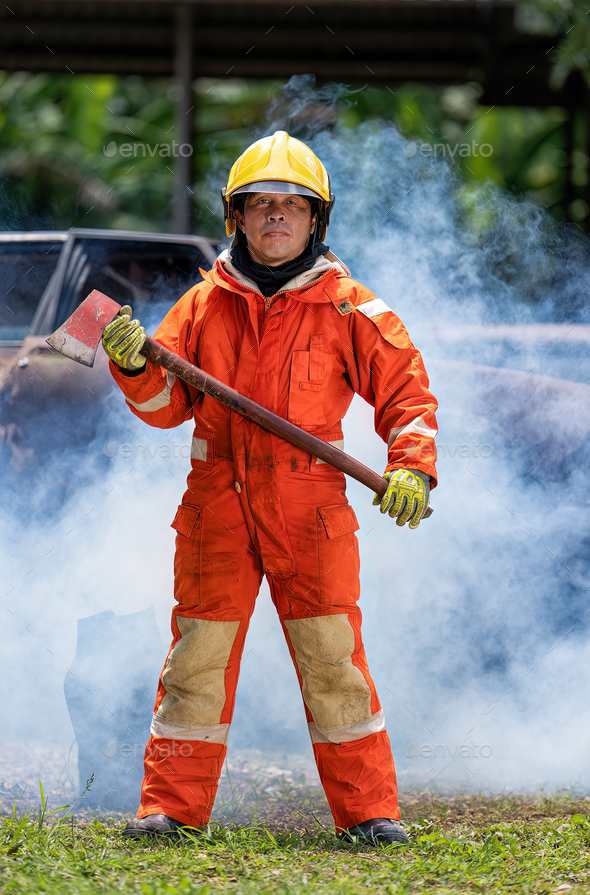 Fireman wearing fire protection suite and oxygen tank hold axe portrait ...